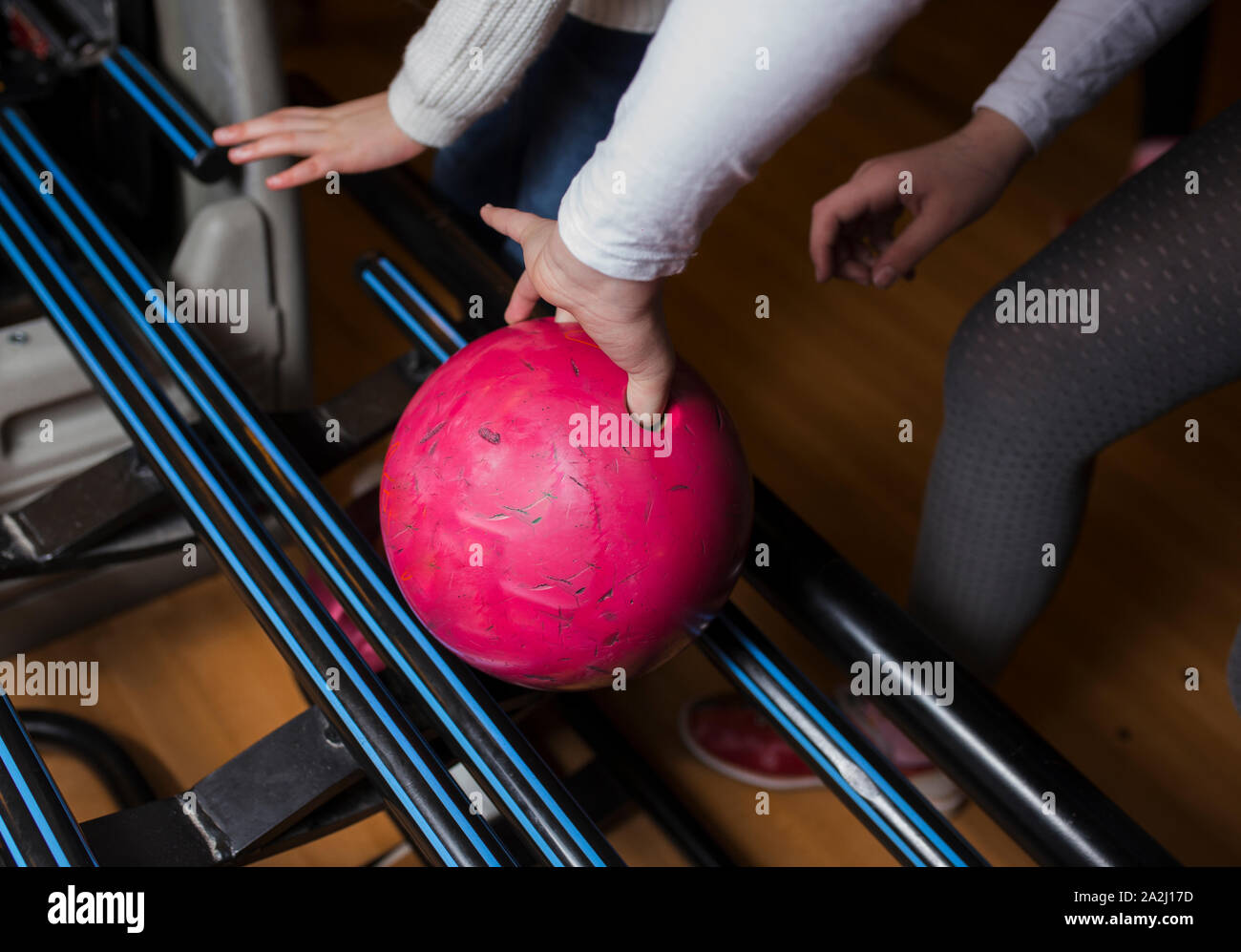 Close-up hand holding bowling ball against bowling alley - Image ...