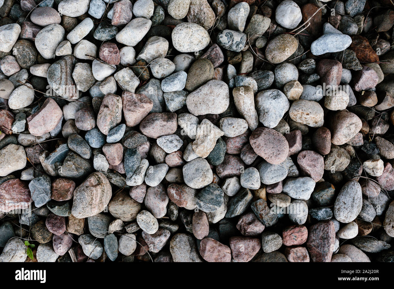 Small rocks on the ground Stock Photo - Alamy