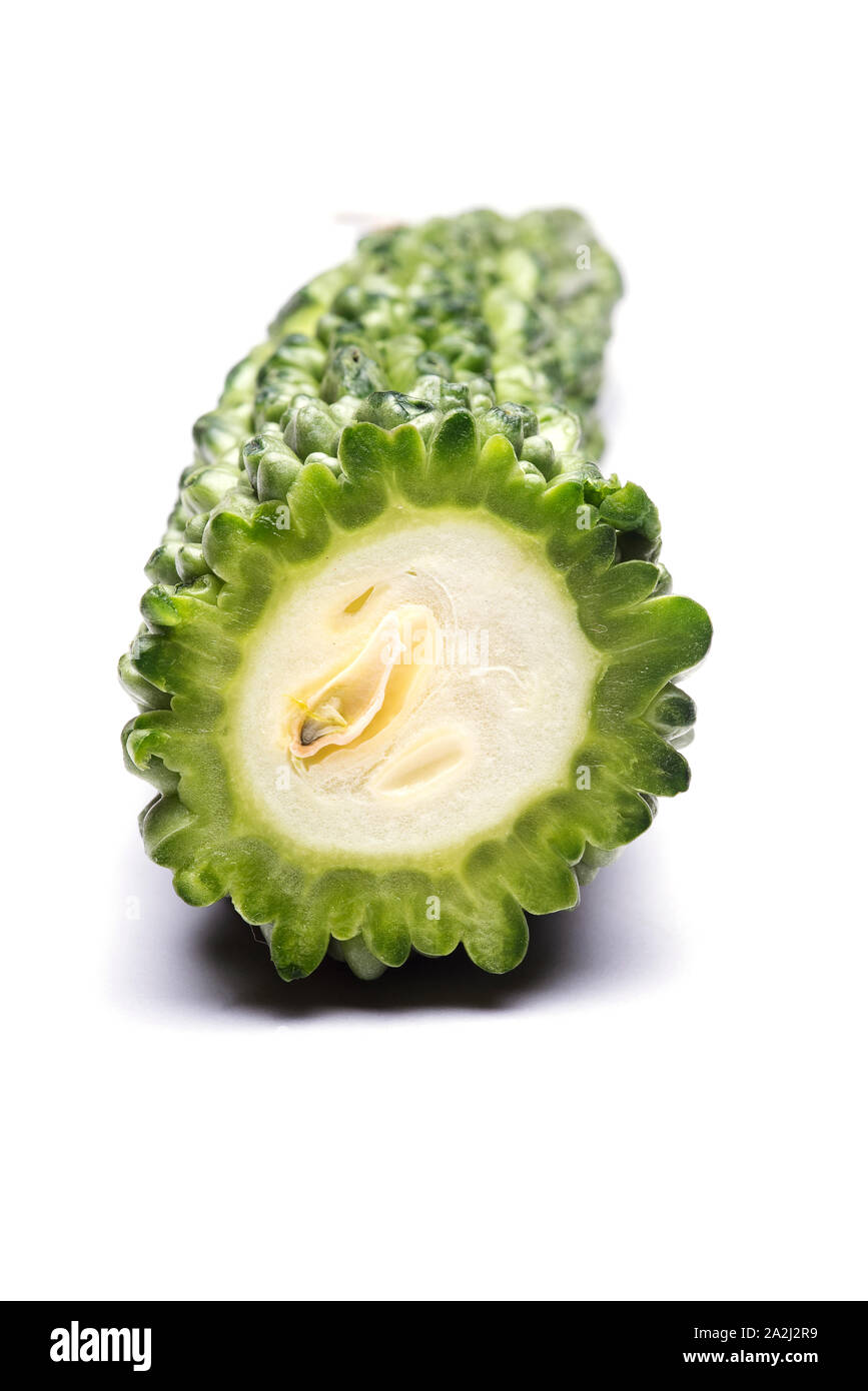 Bitter gourd cut in halves on isolated white background Stock Photo - Alamy