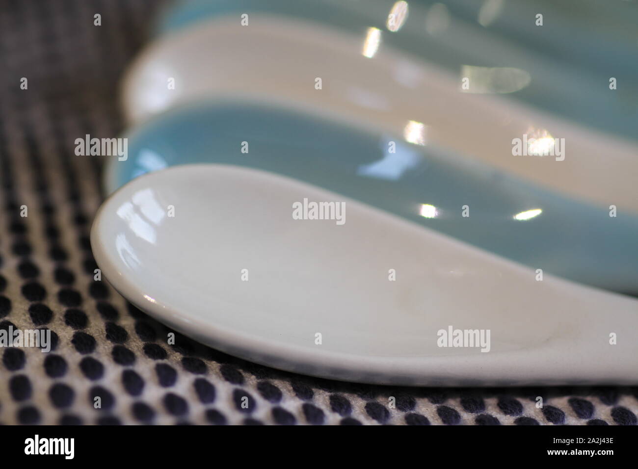 White and blue ceramic spoons under close up lens Stock Photo - Alamy