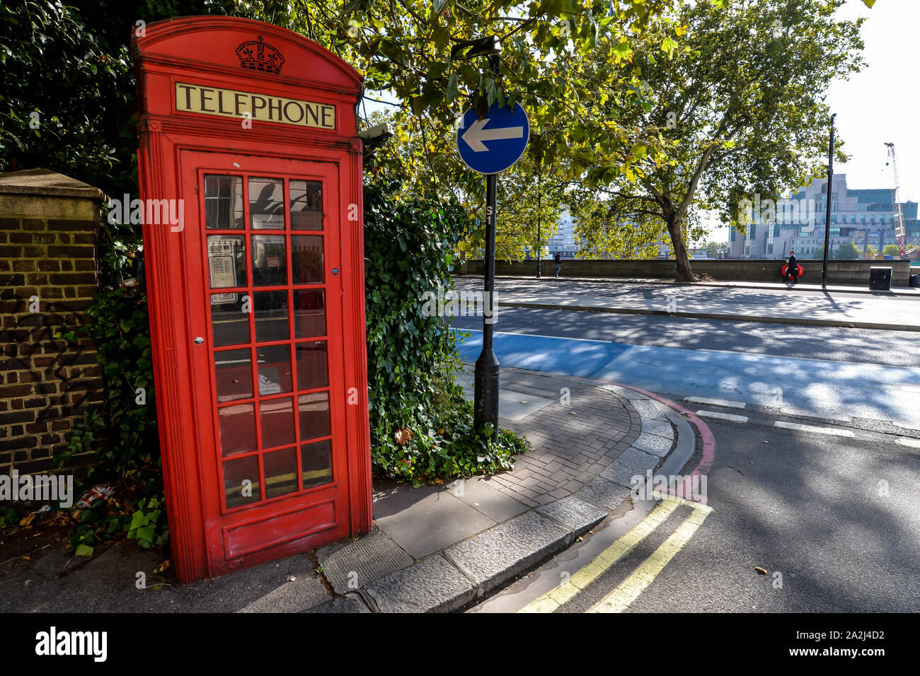 An old phone box in central London and a blue sign Stock Photo - Alamy
