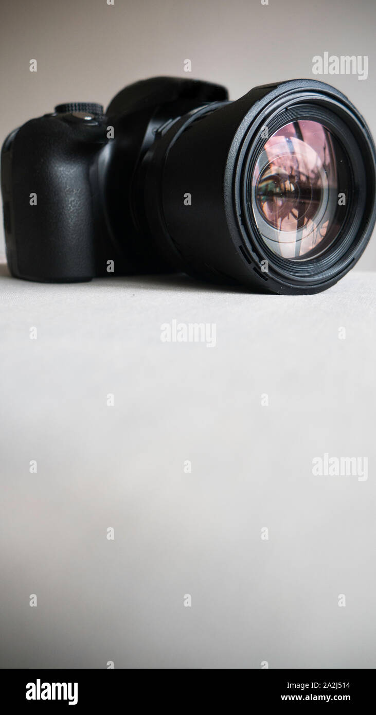 Black digital camera isolated on a light background Stock Photo - Alamy