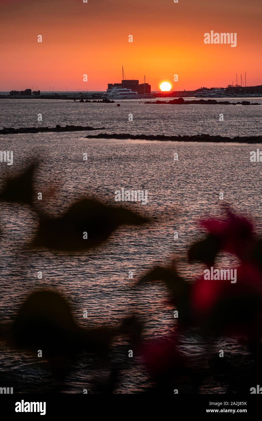 Beautiful sunset view over the Paphos old castle, harbor and the sea in ...