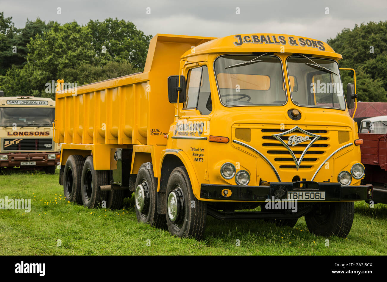 Bright yellow J C Balls and Sons haulage tipper truck on display at a ...