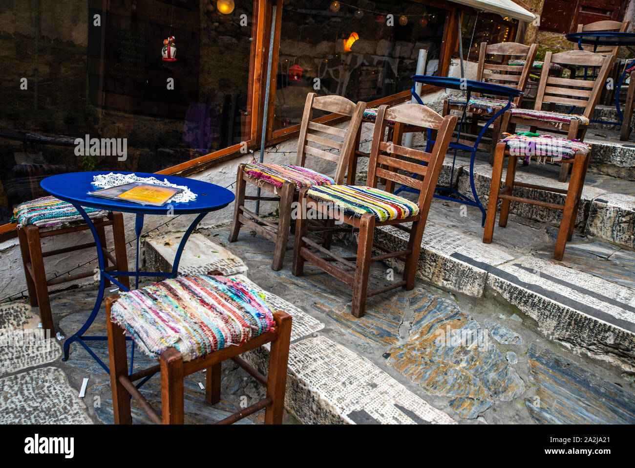 Chairs and tables of a bar on the street stairs in the Plaka ...