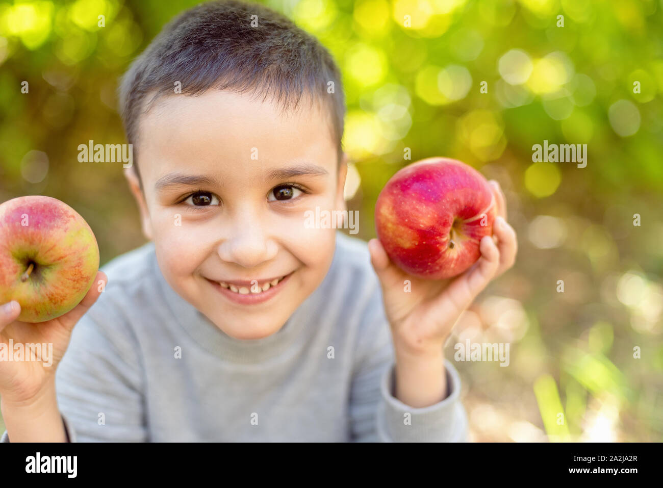 Girl holding apple in front of face hi-res stock photography and images ...