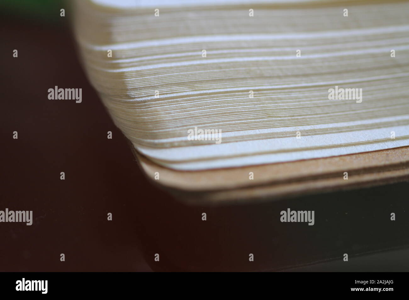 White paper edge on dark background under close up lens Stock Photo - Alamy