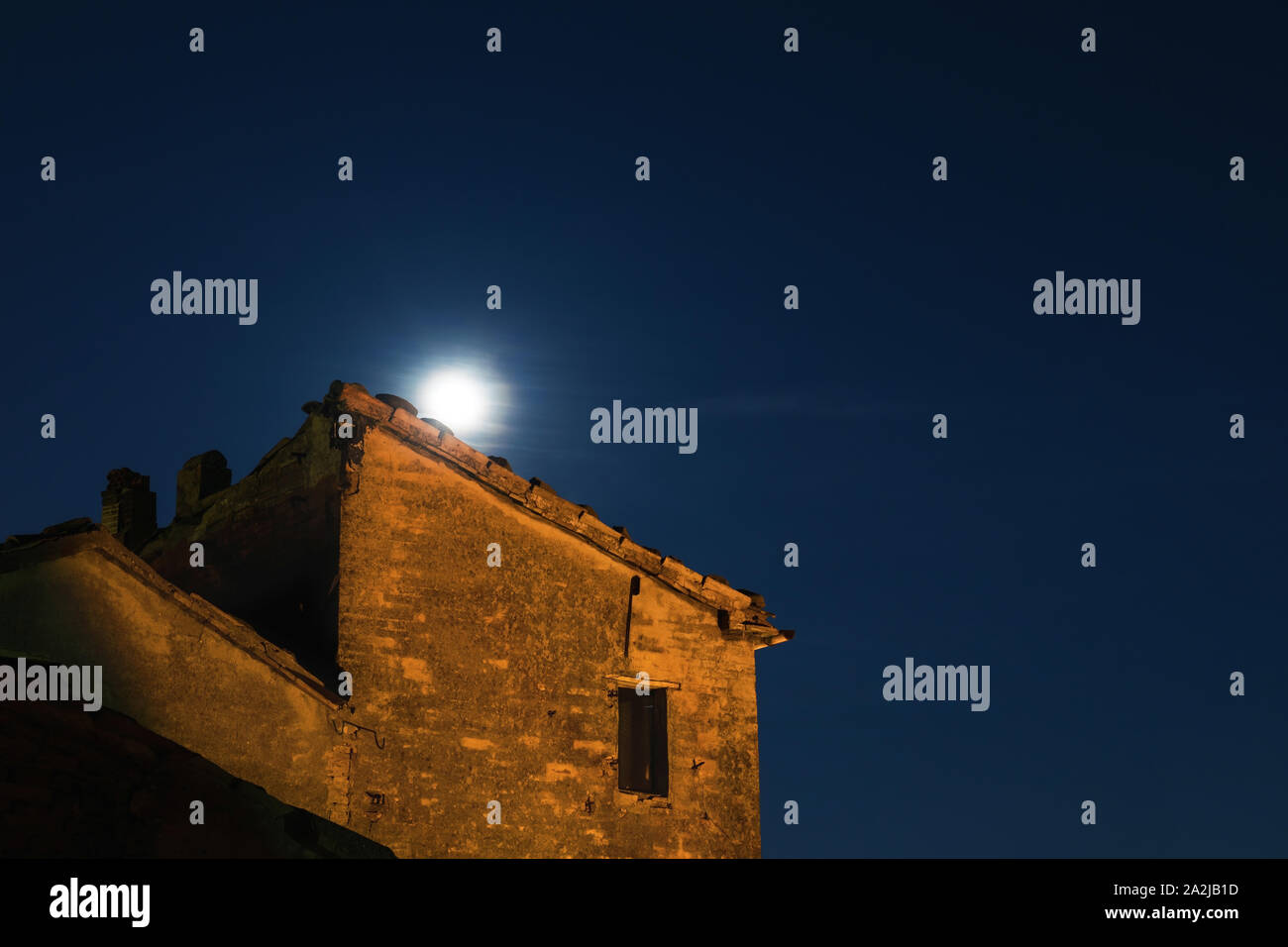 Moon rises behind an ancient ruined building, night view Stock Photo ...