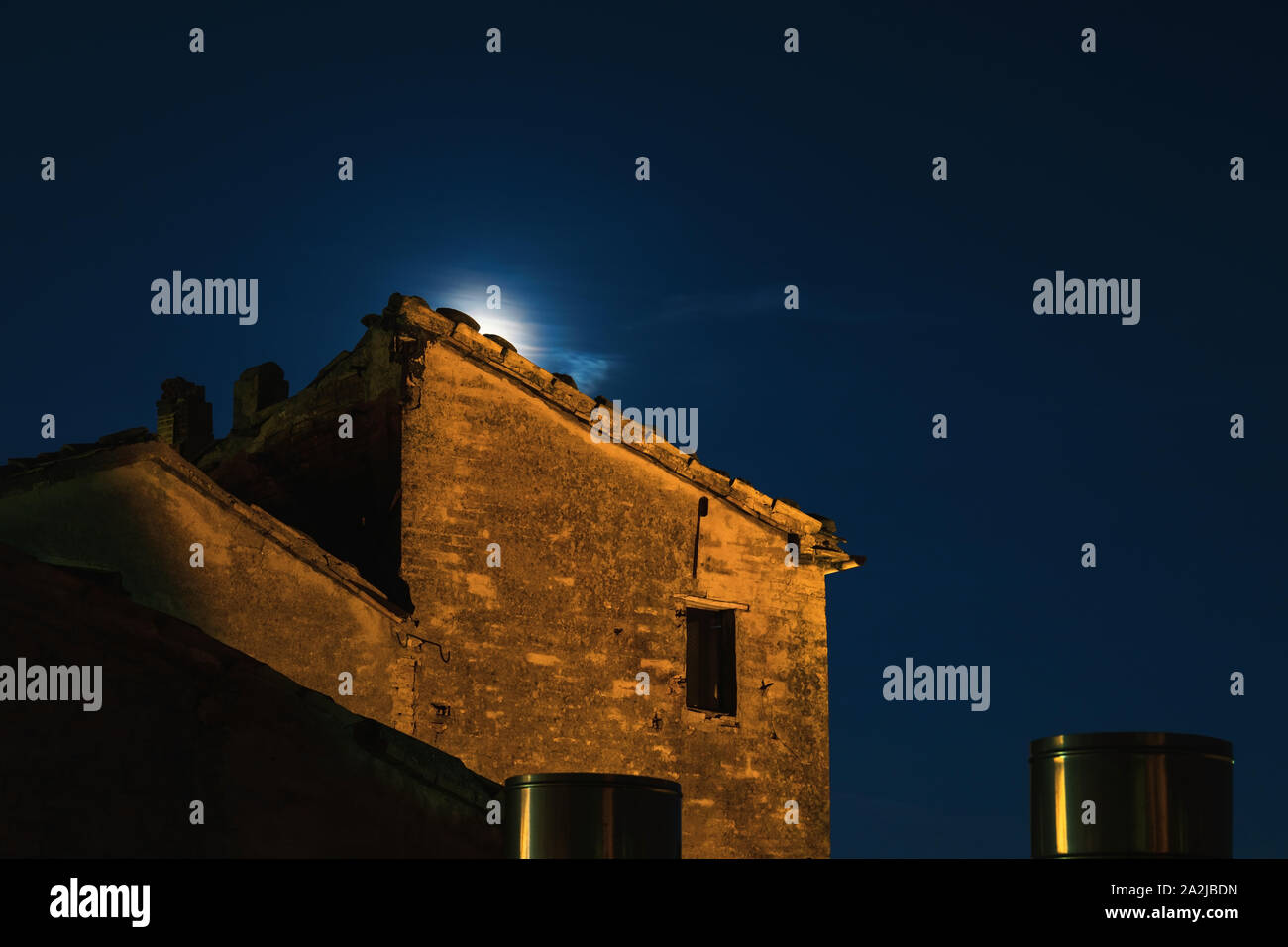 Moon rises behind an ancient ruined building, night view Stock Photo ...