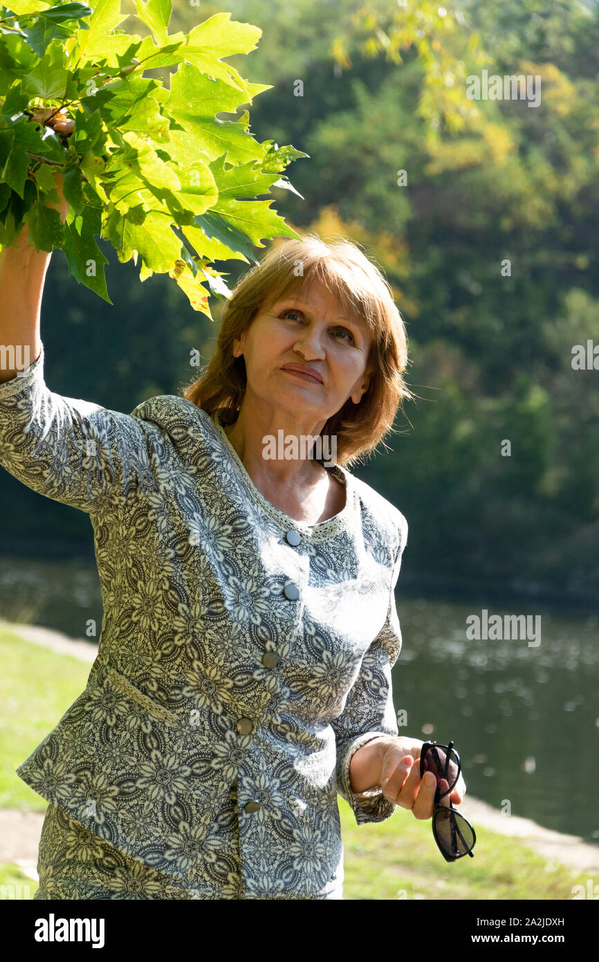 Attractive senior lady in the park. Healthy and active lifestyle ...