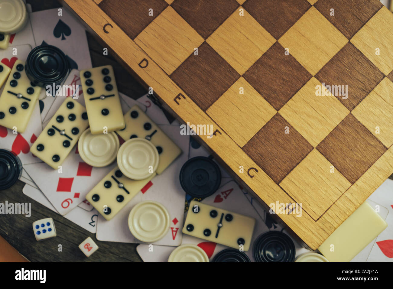 Close up Various board games chess board, playing cards, dominoes on a ...