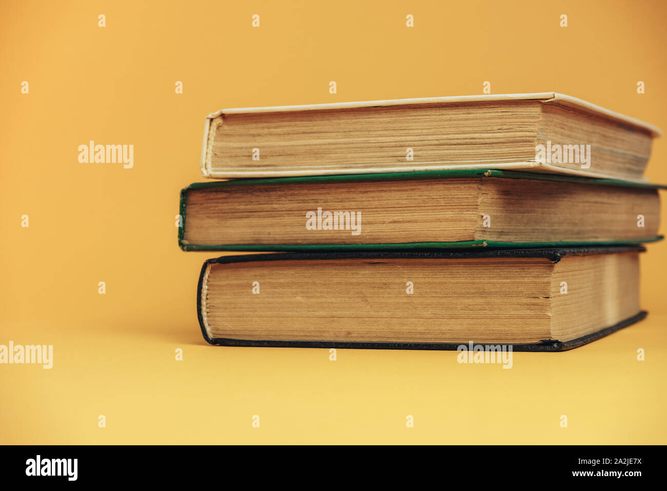 Beautiful old books on a orange background Stock Photo - Alamy