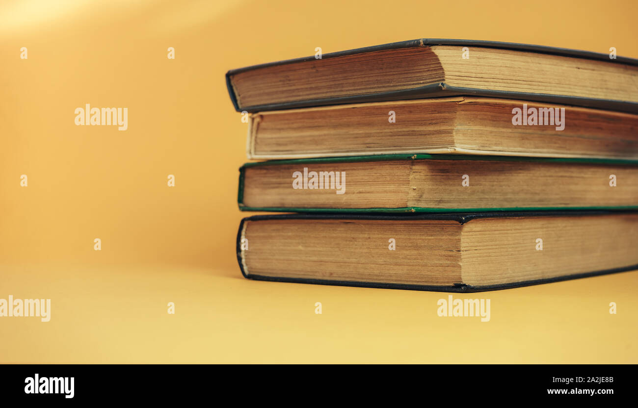 Beautiful old books on a orange background Stock Photo - Alamy