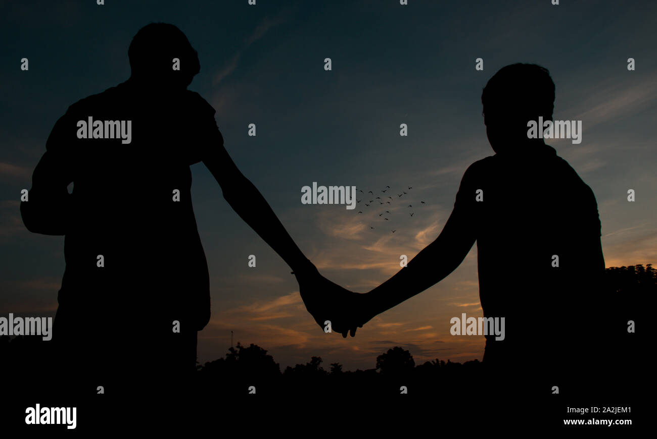 Two boys holding hands hi-res stock photography and images - Alamy