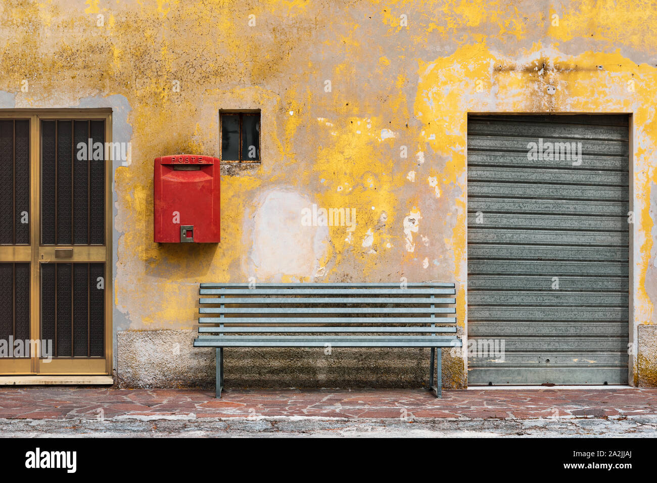 Exterior old building, front view of facade with letterbox and bench ...