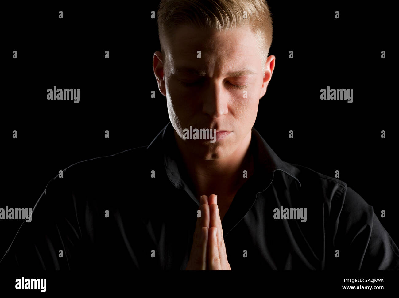 Low key portrait of serious handsome man with eyes closed Stock Photo ...