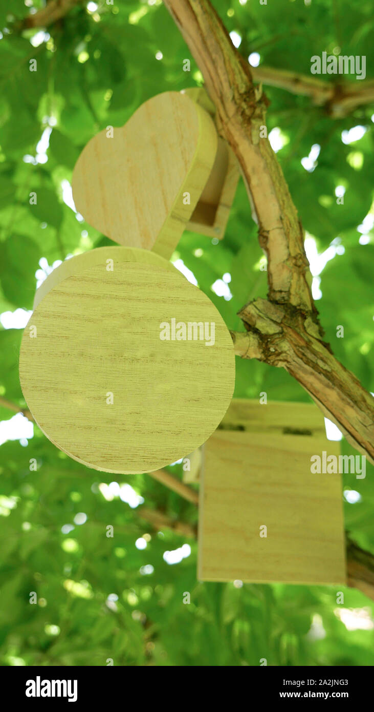 Wooden closed boxes in the shape of a cube, heart and circle in the ...