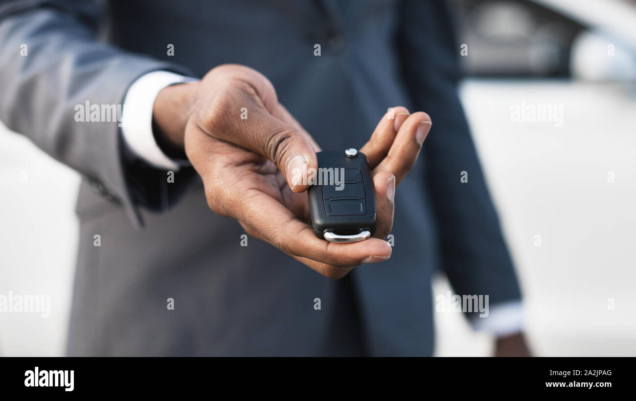 Car rental concept. Man holding car key in hand Stock Photo - Alamy