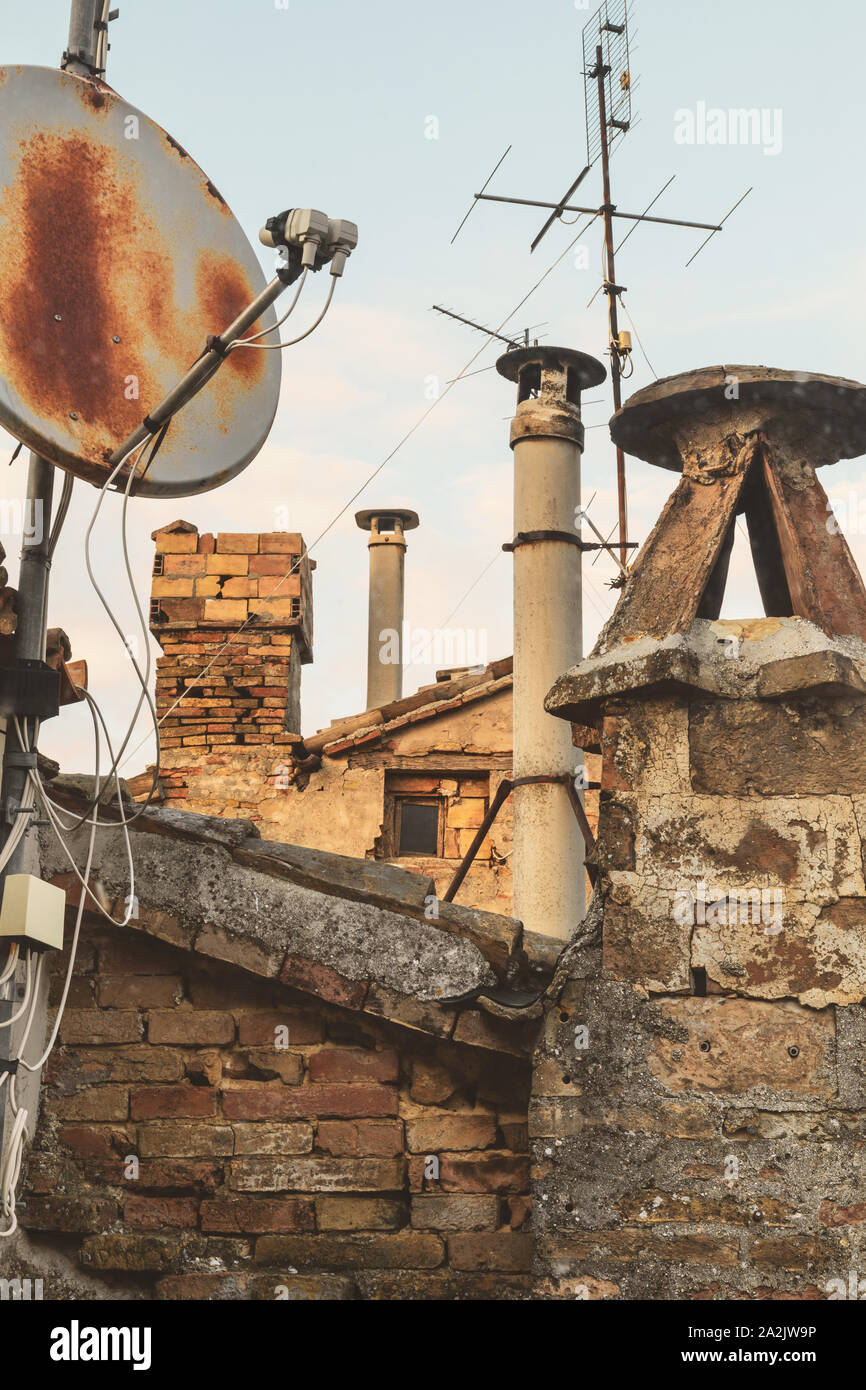 Old brick chimneys and battered antennas, view from the roofs Stock ...