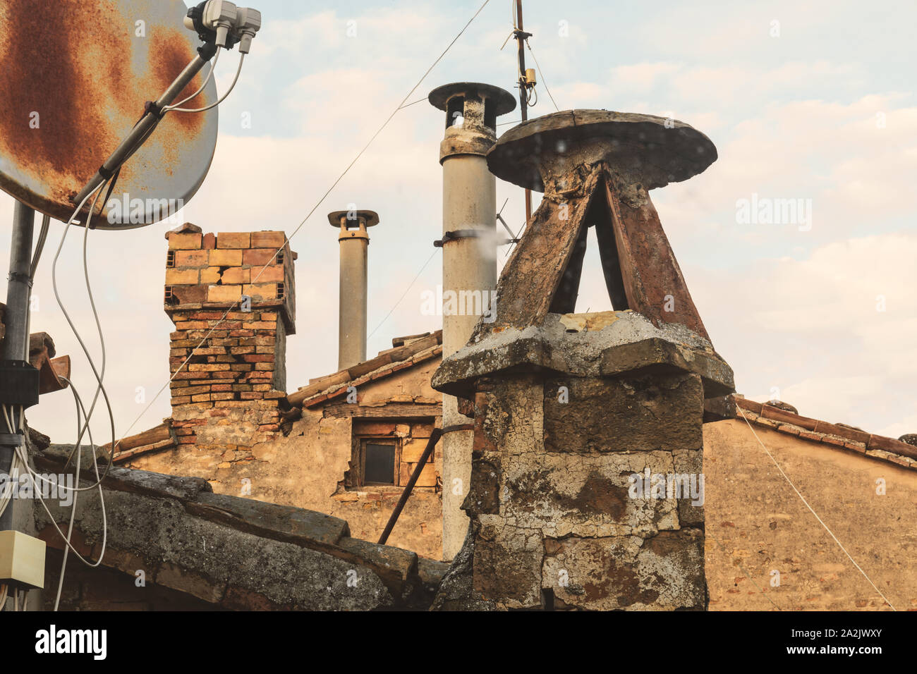 Old brick chimneys and battered antennas, view from the roofs Stock ...