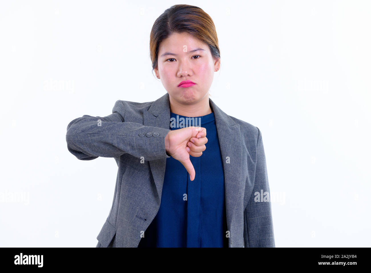 Stressed young Asian businesswoman giving thumbs down Stock Photo - Alamy