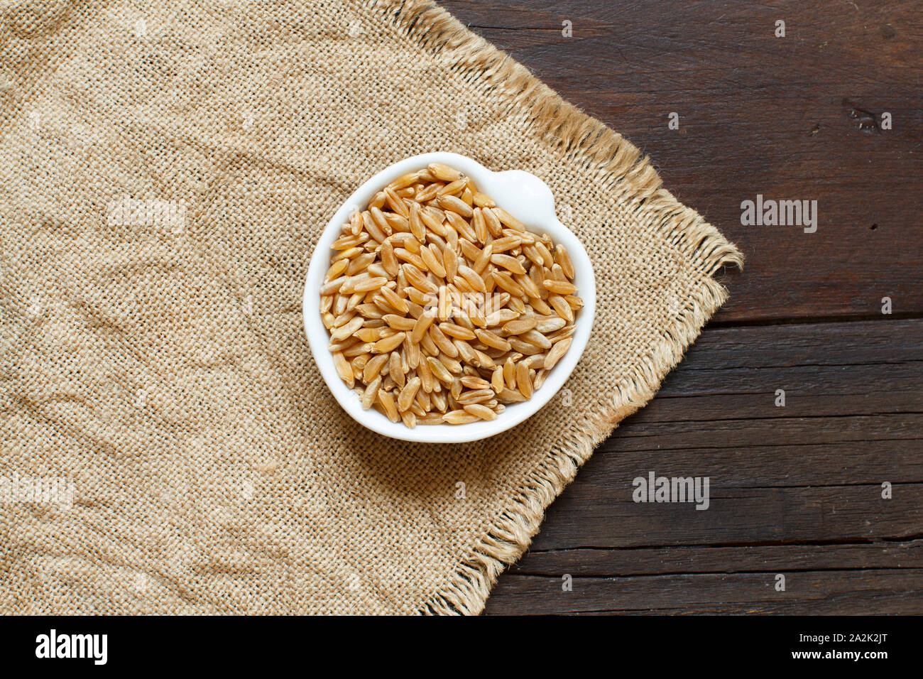 Kamut grain in a boel on wooden background top view Stock Photo - Alamy
