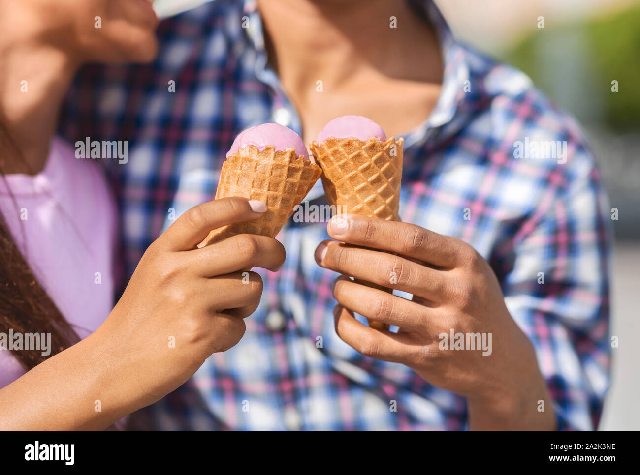 Young couple eating ice cream cones together Stock Photo - Alamy
