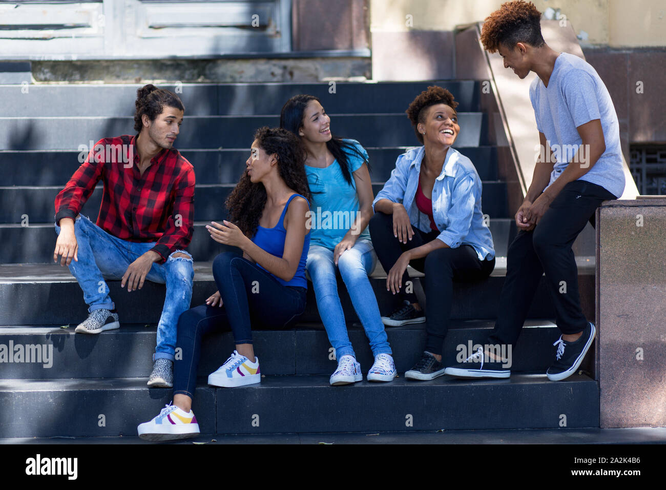 Group of talking latin american and hispanic young adult immigrants in ...