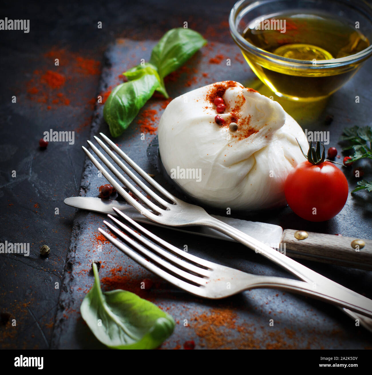Italian cheese burrata, tomatoes, basil and olive oil Stock Photo - Alamy