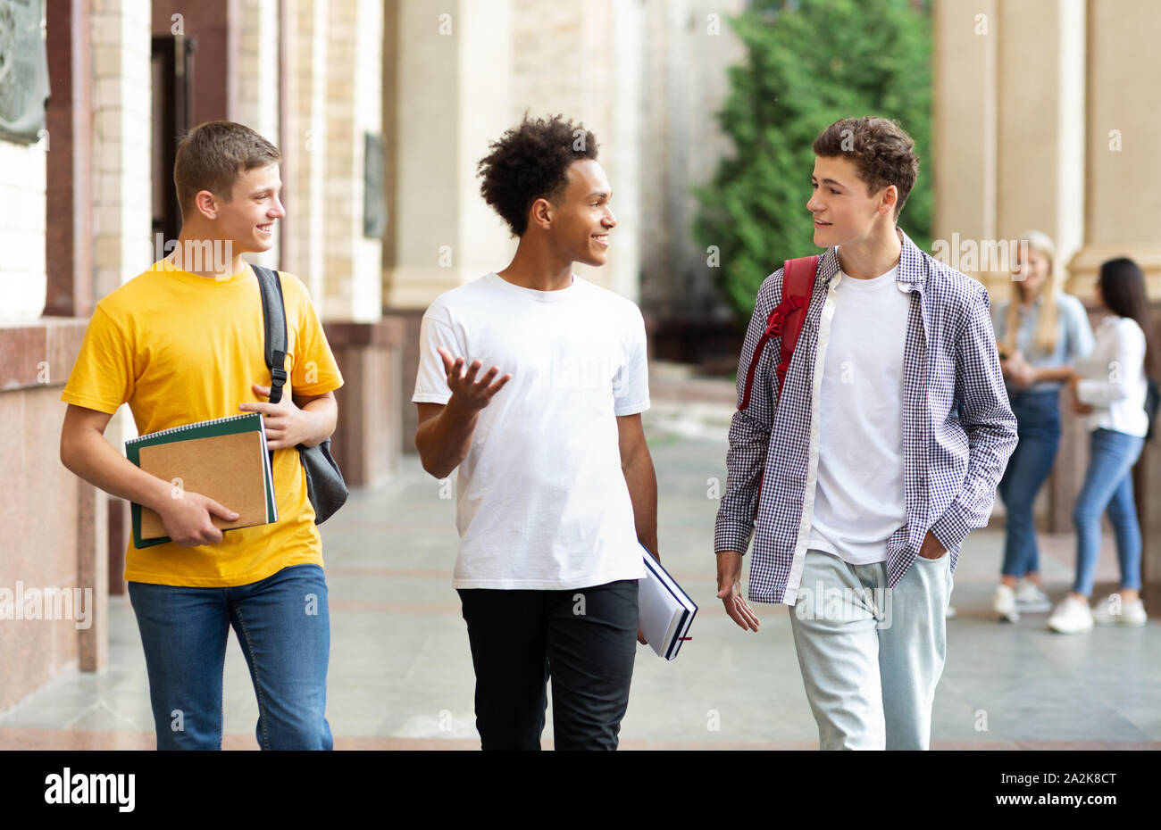 Three guys walking together in hi-res stock photography and images - Alamy