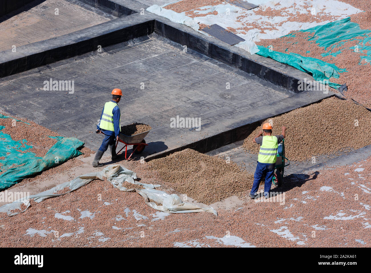 The process of thermal insulation of the roof by workers, by filling ...
