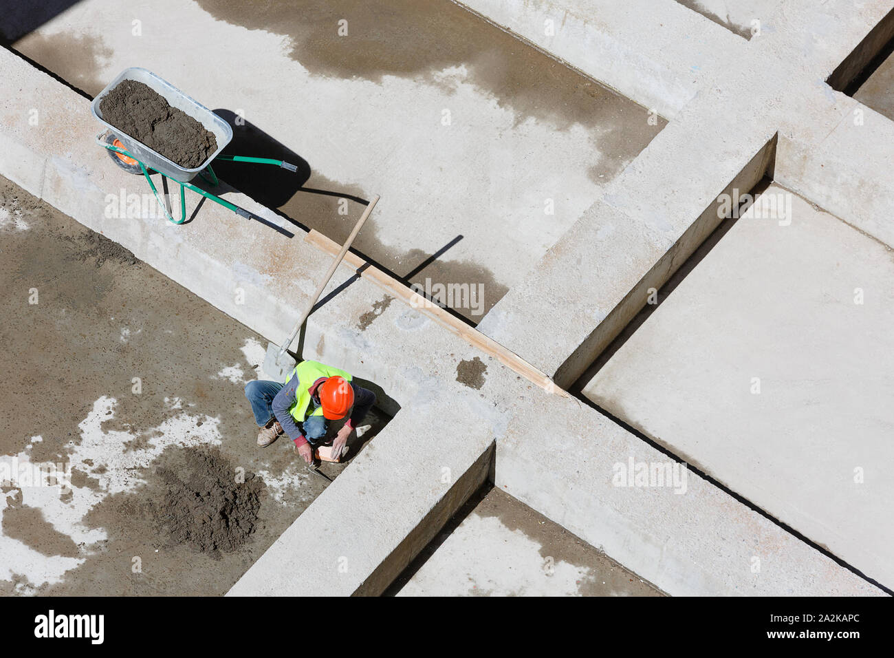 Uniformed workers clean sand on a construction site, top view Stock ...
