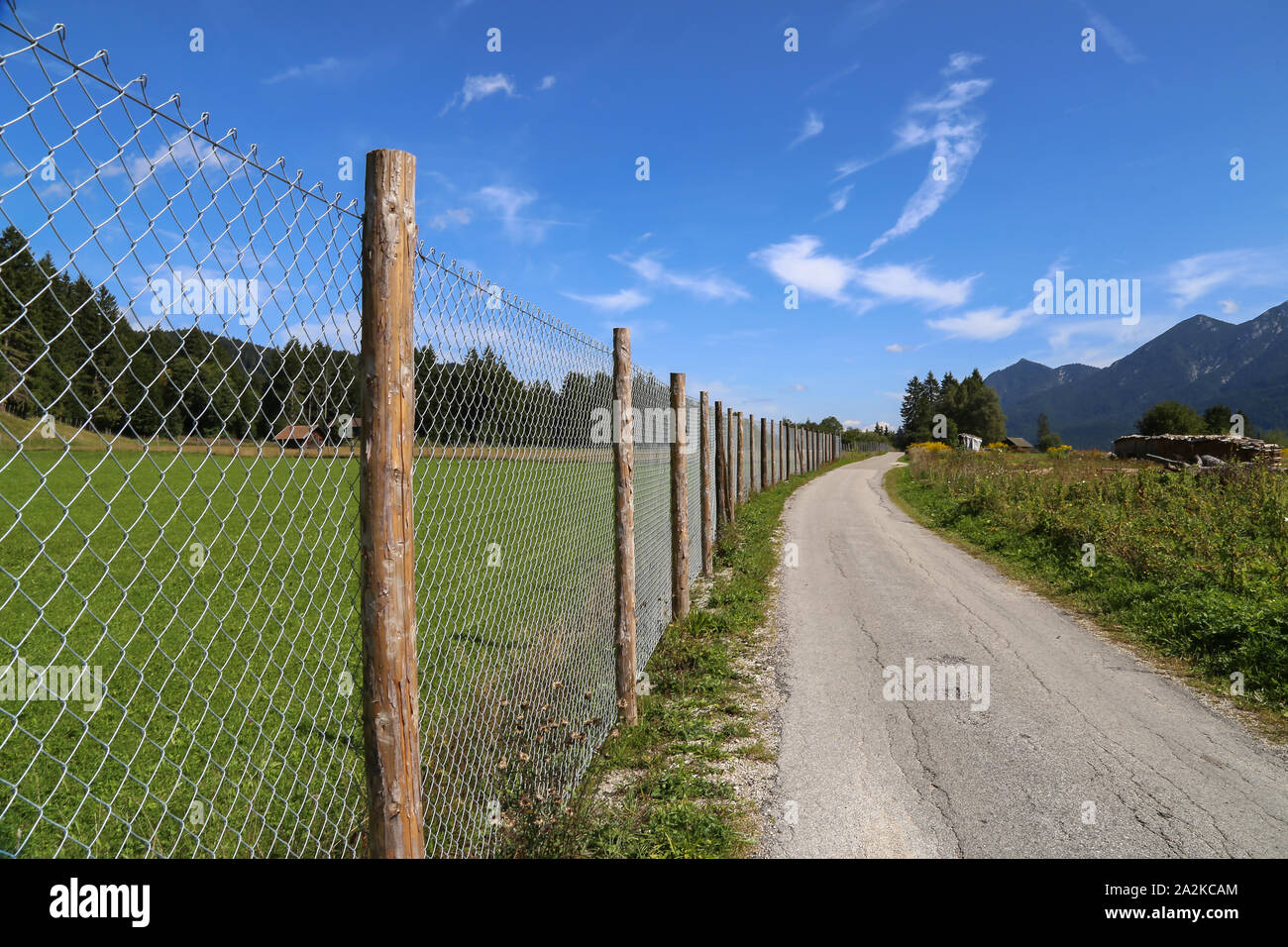 Metal mesh fence along the field road Stock Photo - Alamy