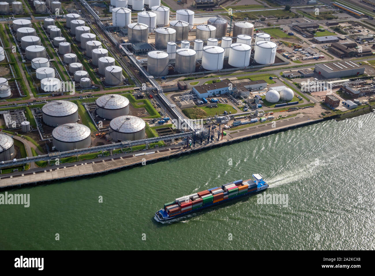 Aerial view of a ship pasing an oil storage silo terminal port Stock ...