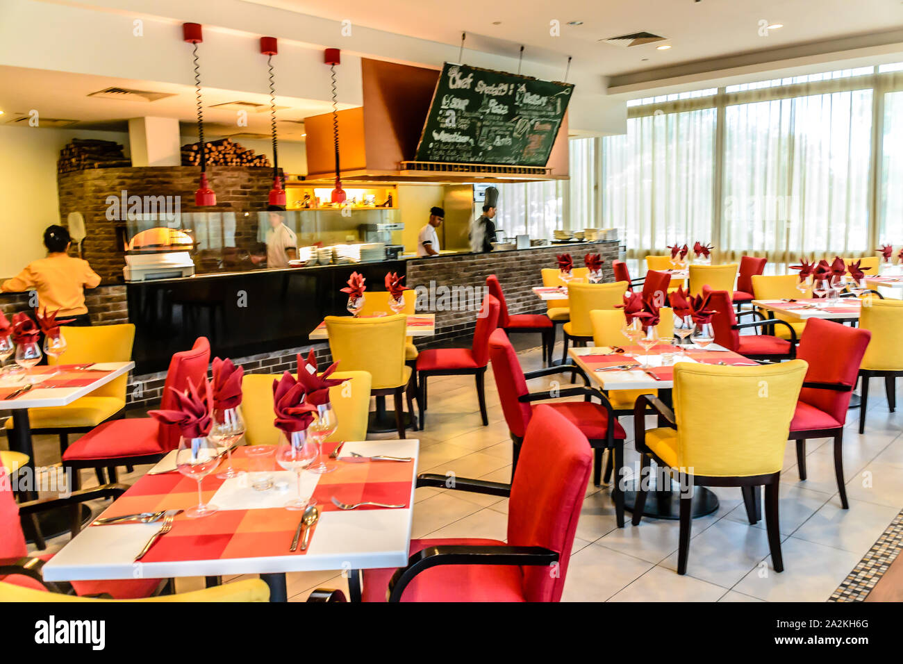 colourful tables and chairs seating area in a restaurant with an open ...