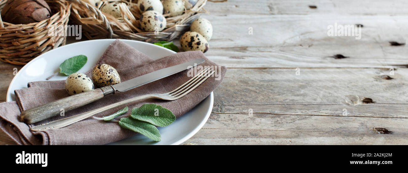Rustic Easter table setting with eggs and herbs on a wooden table Stock ...