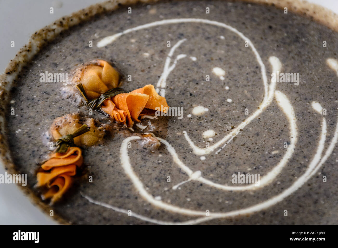 cream of mushroom soup served in a white china dish and topped with 2 ...