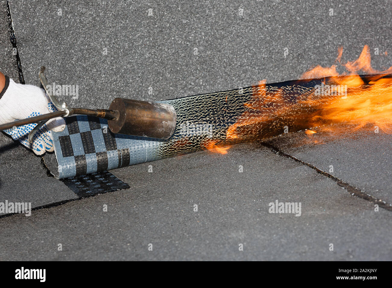 Laying waterproofing by heating roofing felt with fire Stock Photo - Alamy