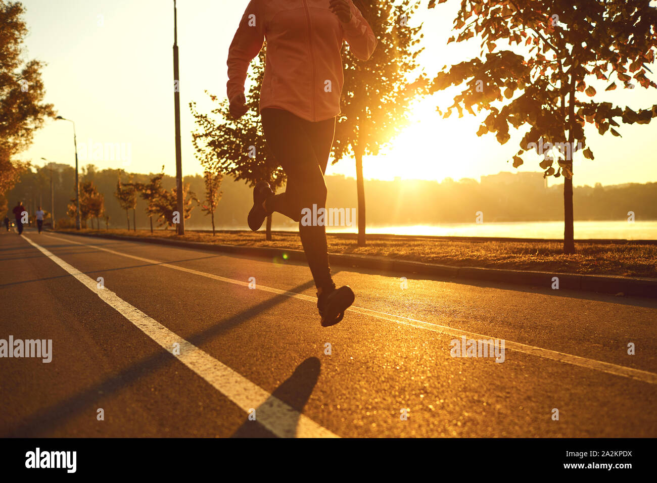 Female runner at sunset hi-res stock photography and images - Alamy