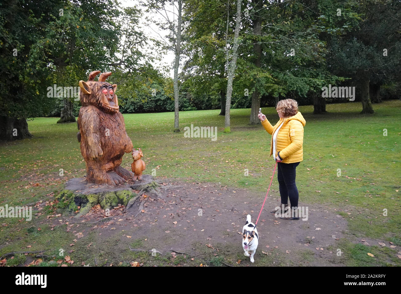 A woman takes a photo of a Gruffalo statue in Hazlehead Park in ...