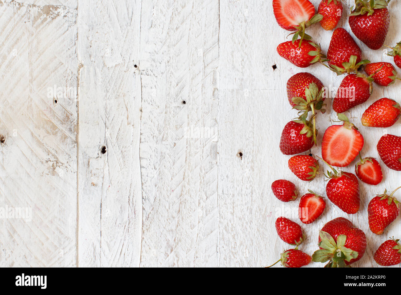 Strawberries on a white wooden table top view Stock Photo - Alamy