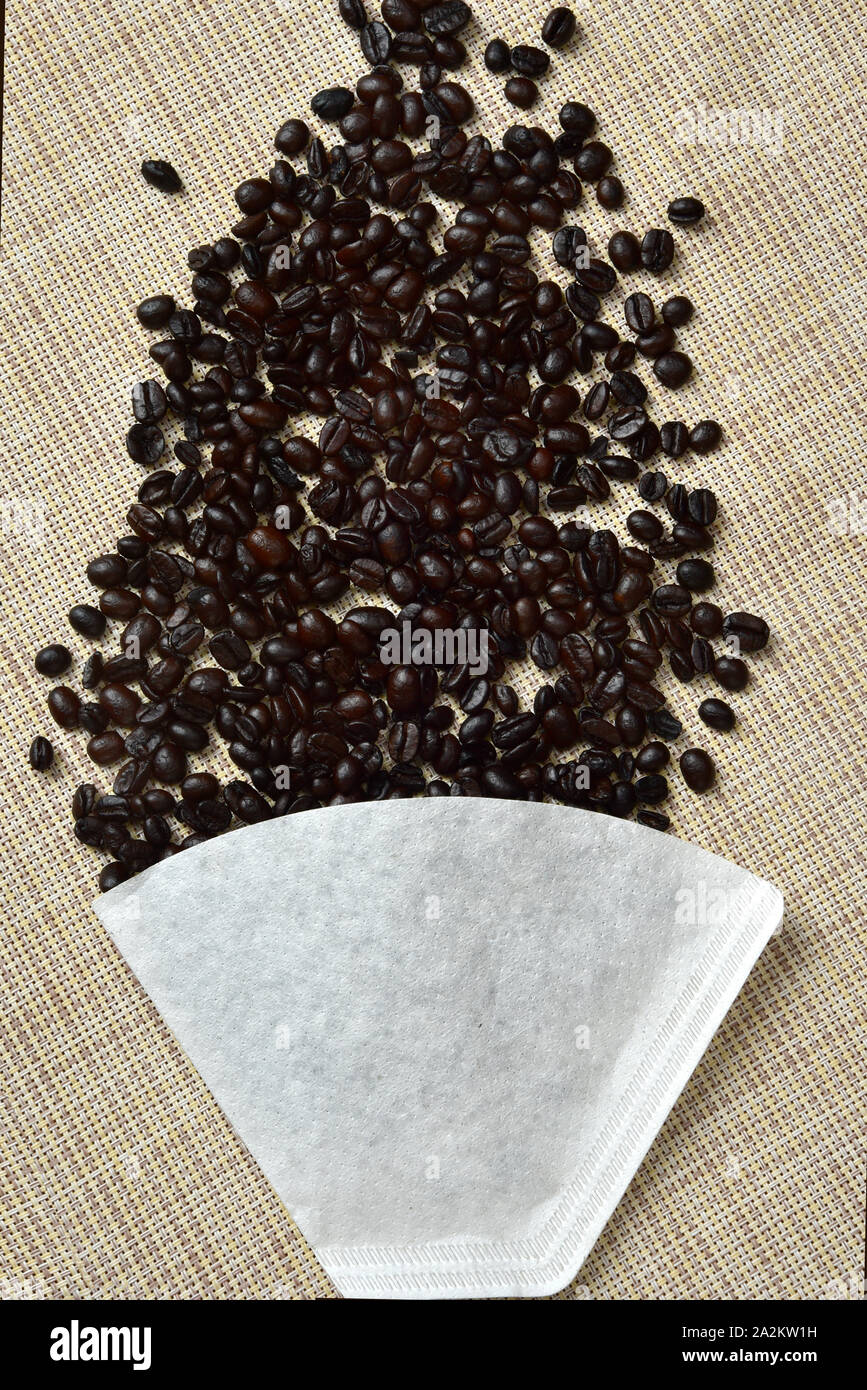 roasted coffee bean and paper colander Stock Photo - Alamy