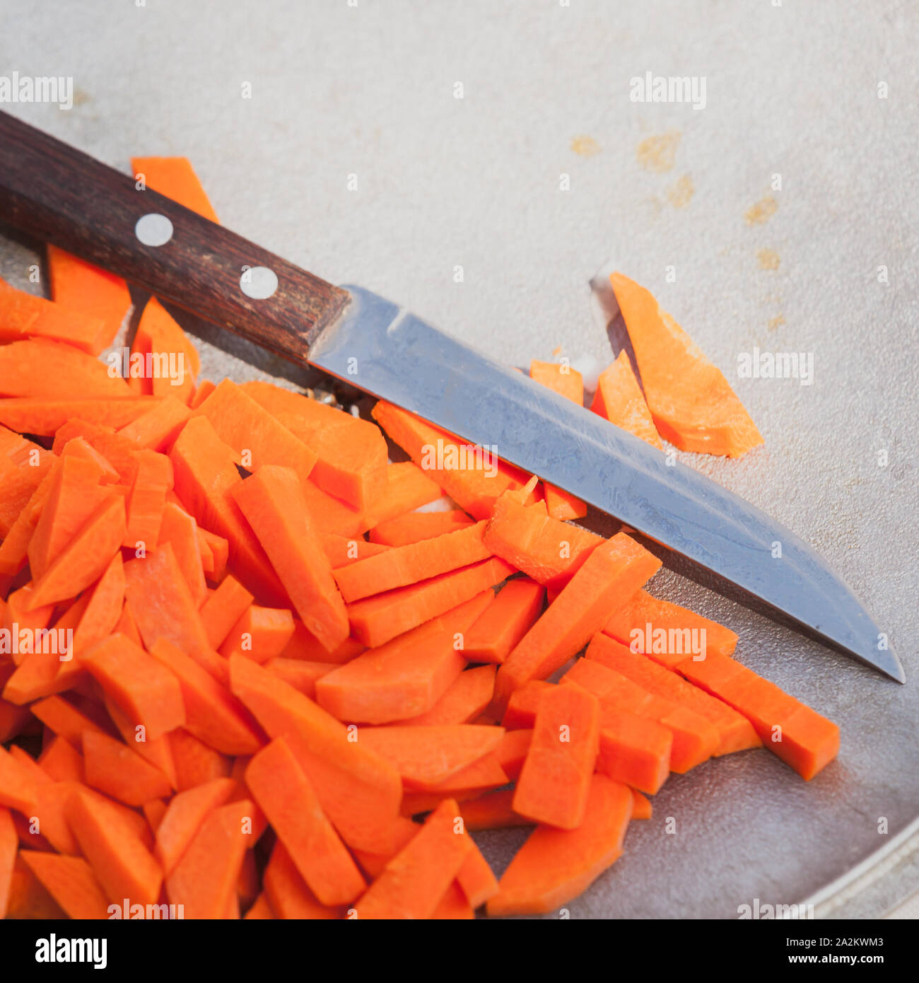 Sliced carrot and kitchen knife, close-up square photo, top view Stock ...