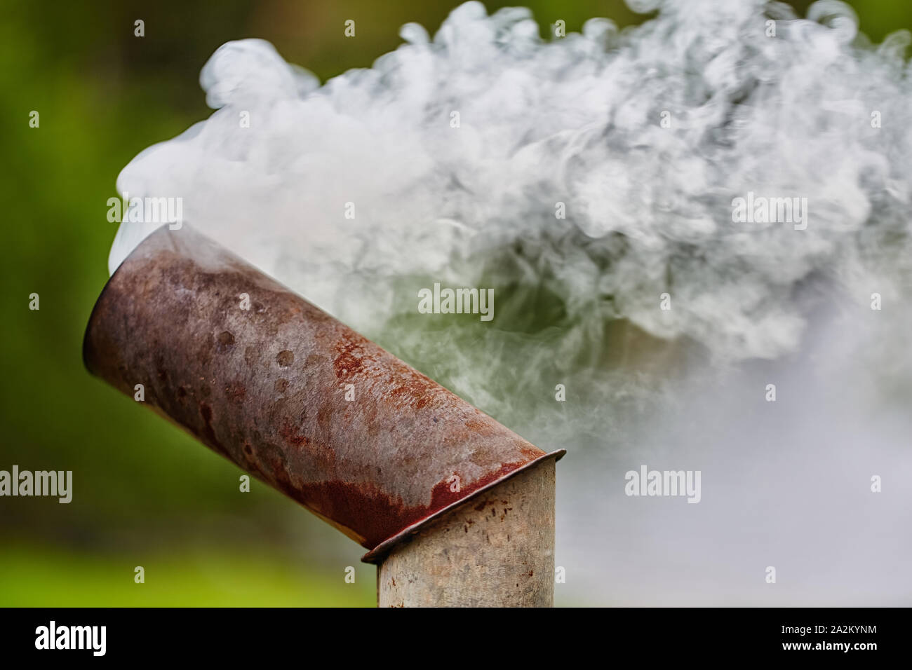 Smoke from an old rusty metal pipe from a street stove, hearth Stock ...