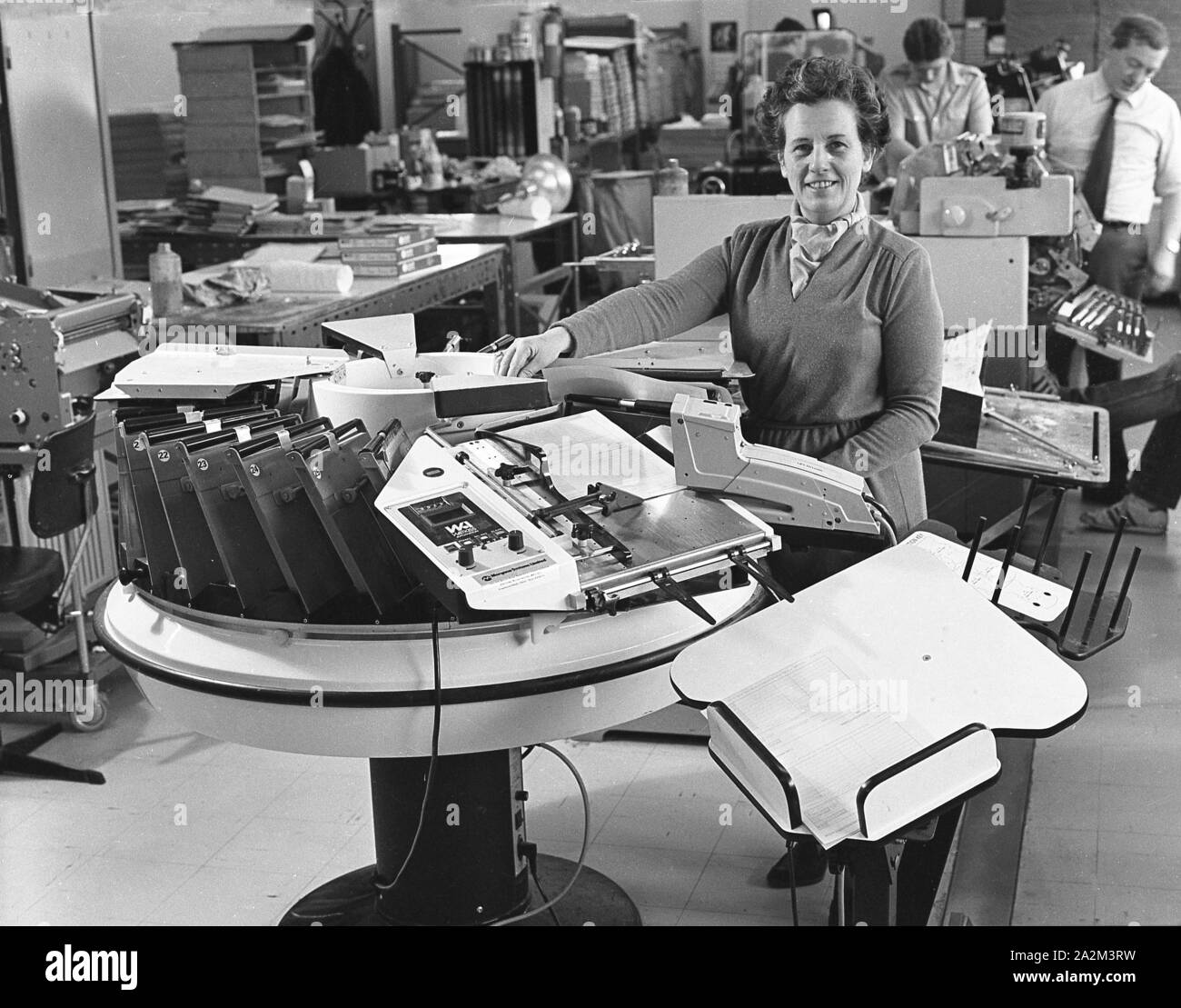 1970s, historical, lady working at a printers using a electronic ...