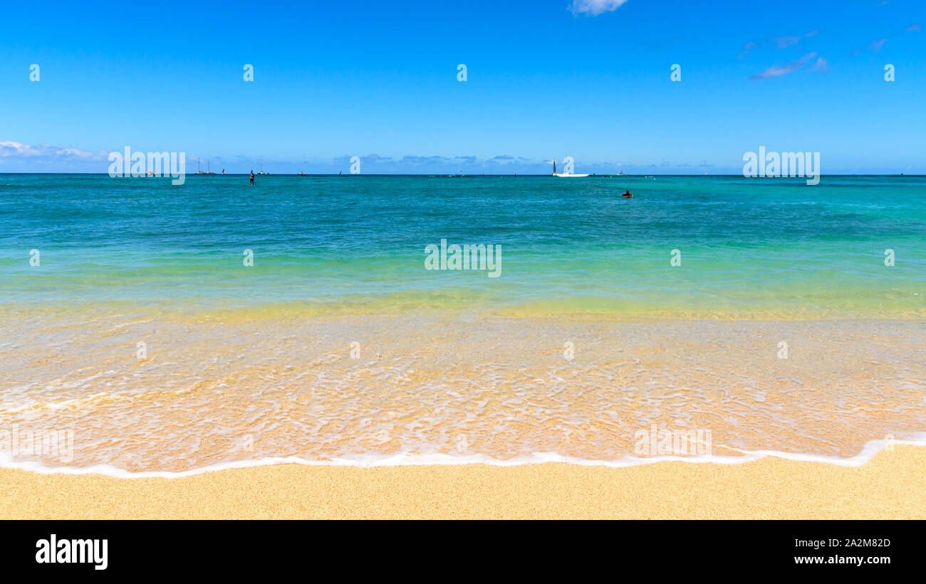 Colourful shore of a tropical beach. The sand is golden yellow, and the ...