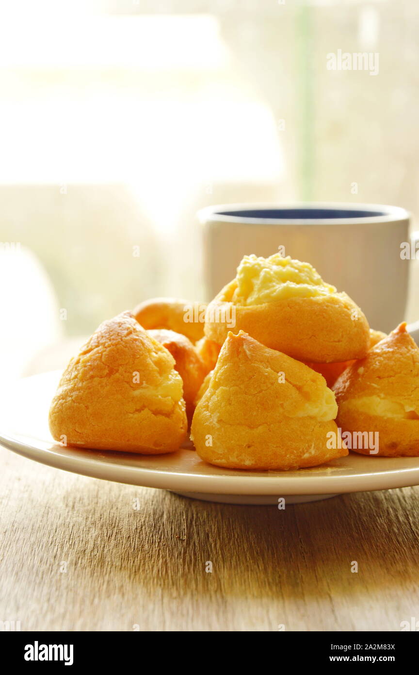 vanilla cream puff on dish and coffee cup Stock Photo - Alamy