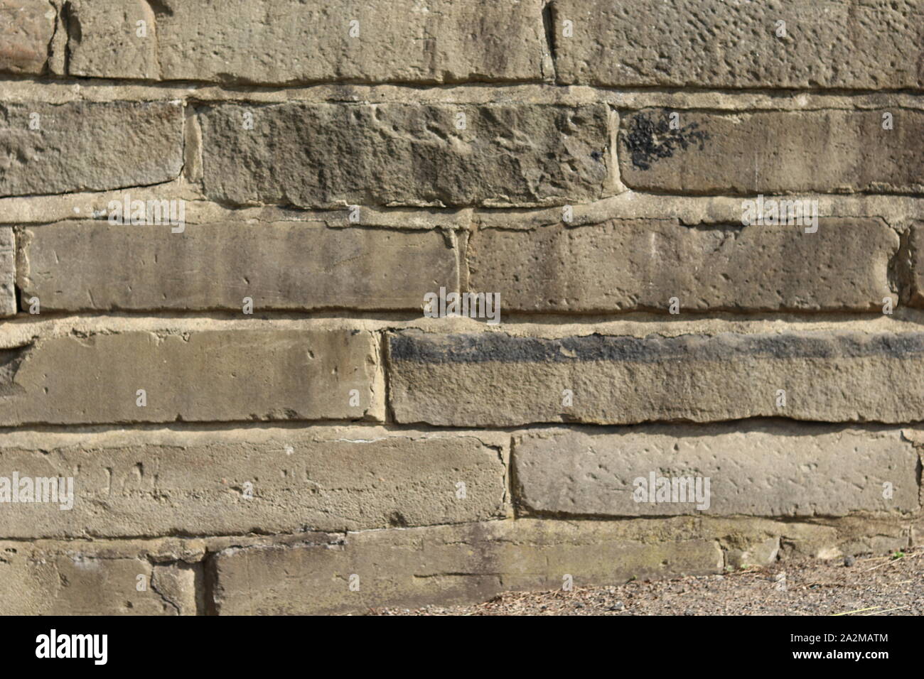 An old stone retaining wall Stock Photo - Alamy