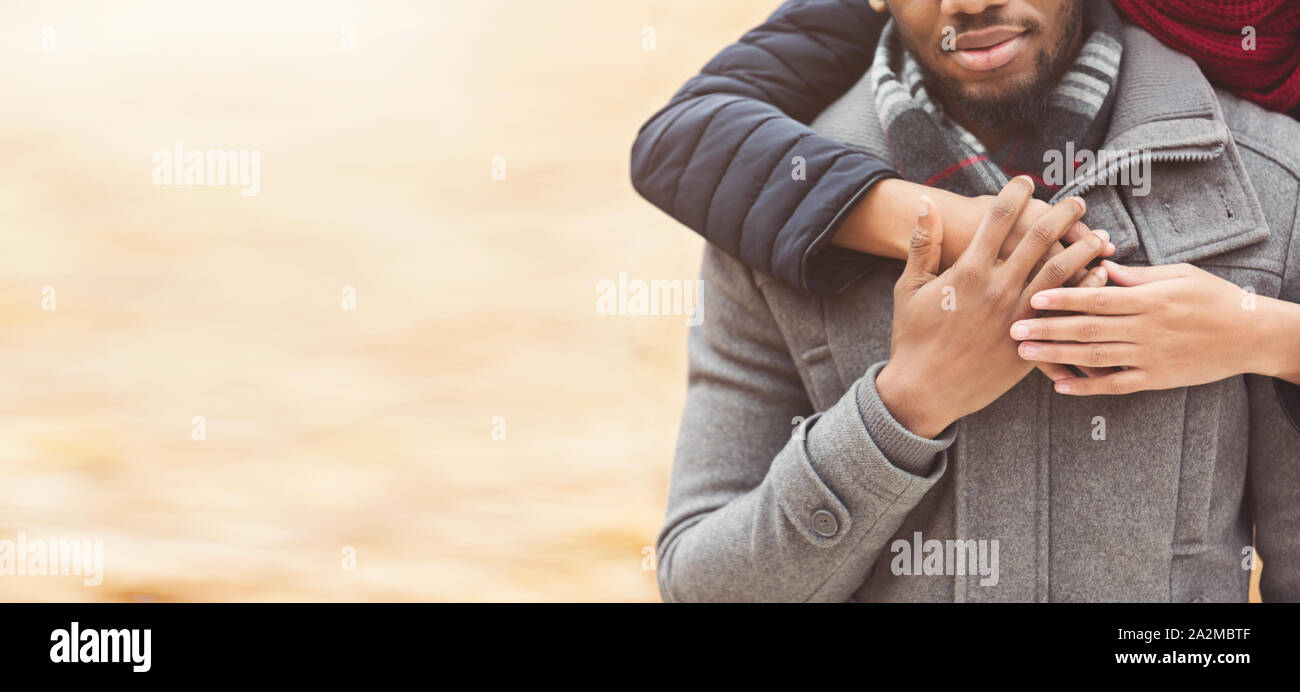 Woman hugging man from back, walking outdoors Stock Photo - Alamy
