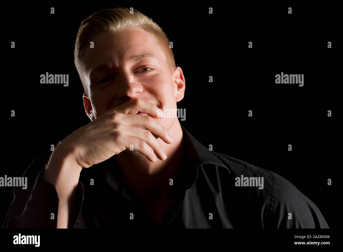 Low key portrait of joyful man looking straight Stock Photo - Alamy